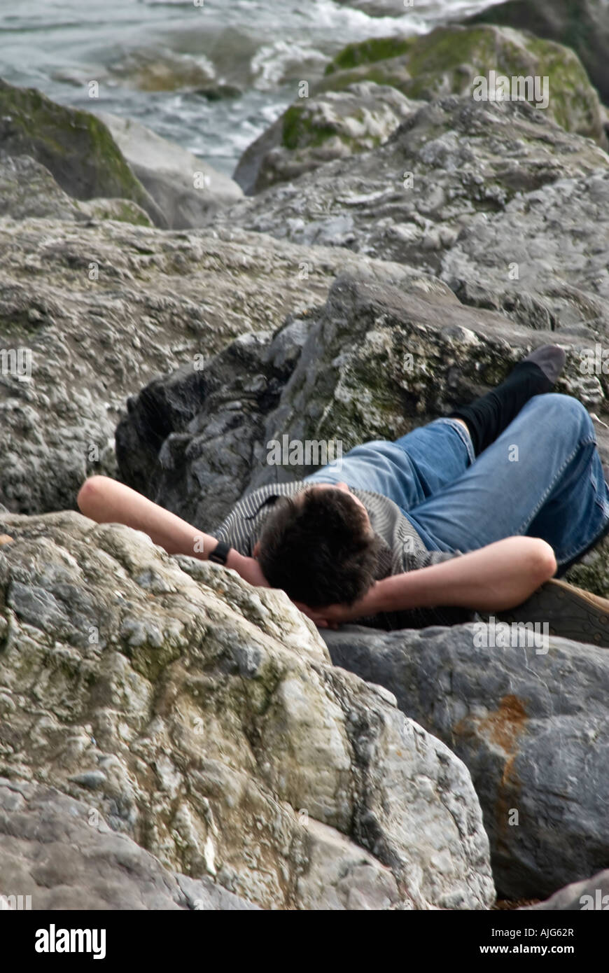 Male laying on rocks hi-res stock photography and images - Alamy