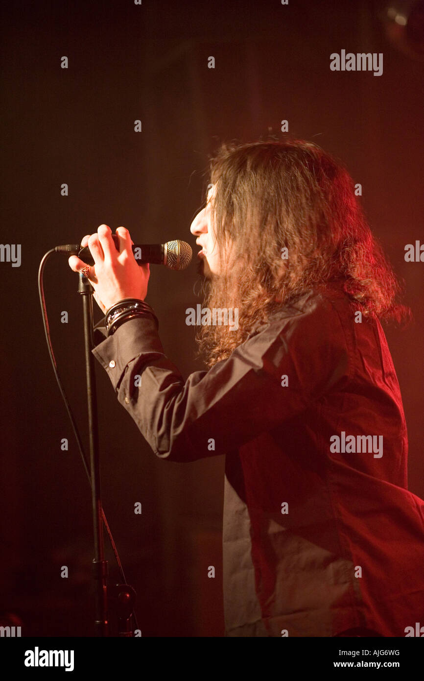 Young man singing on stage Stock Photo - Alamy