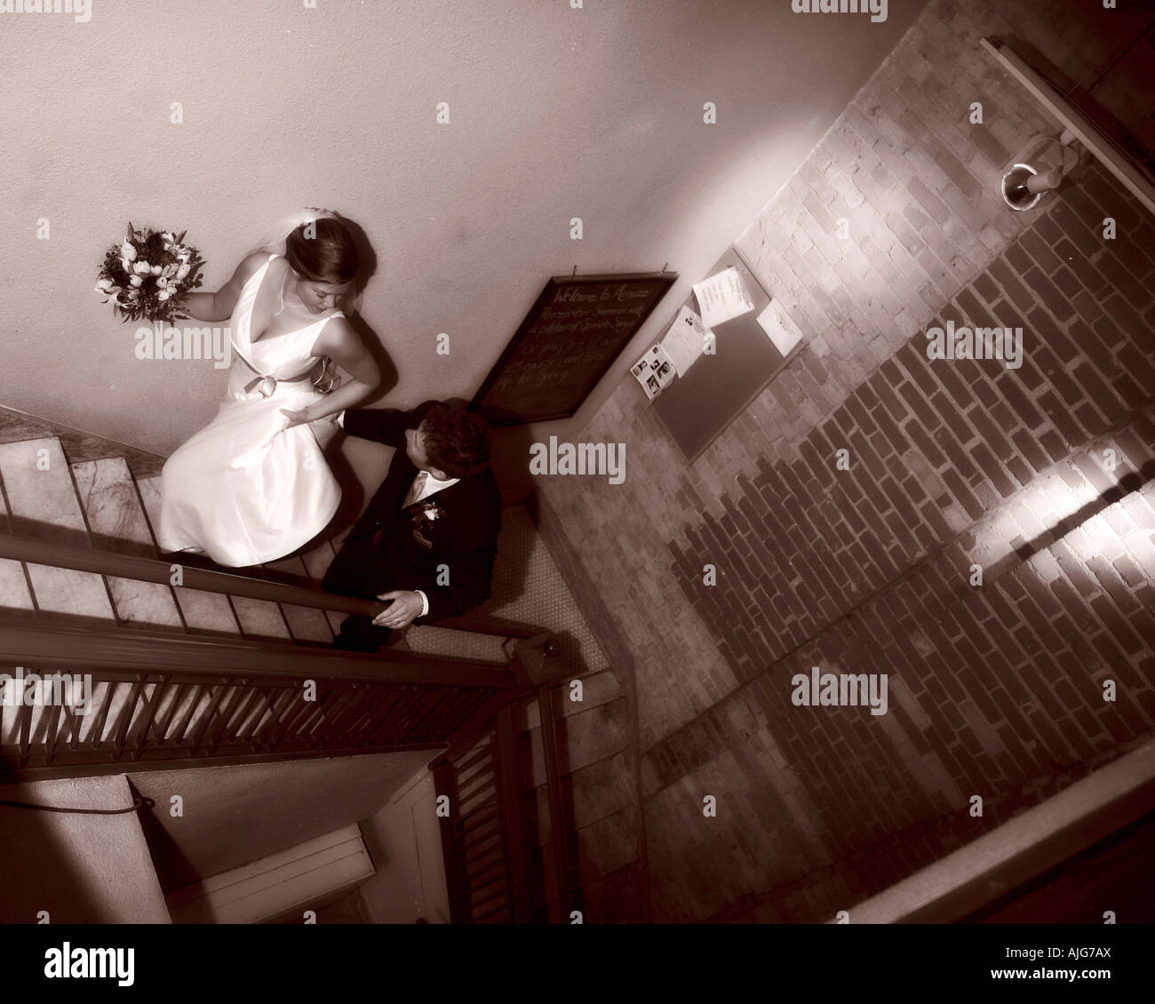 Bride and groom climbing stairs Stock Photo - Alamy