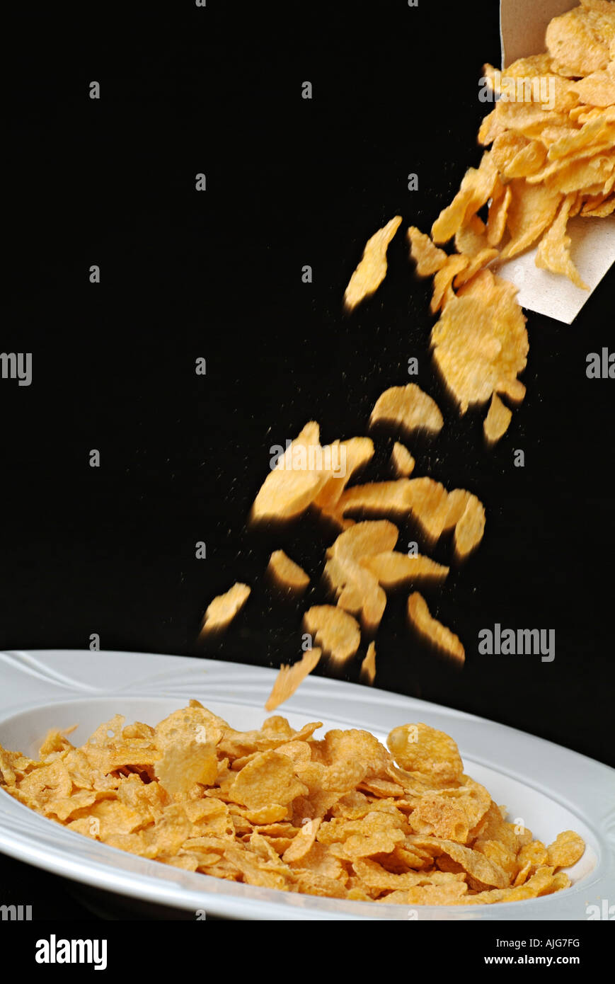 Cornflakes Being Poured Into a Bowl Stock Photo - Alamy
