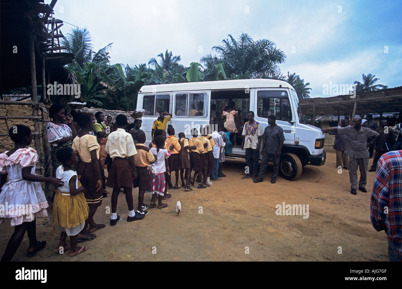 School children getting on school bus Teberebie village Western Ghana ...