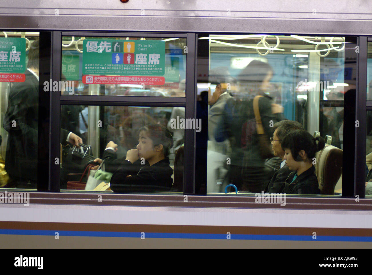 People waiting in a queue on a railway platform Osaka Japan Stock Photo ...