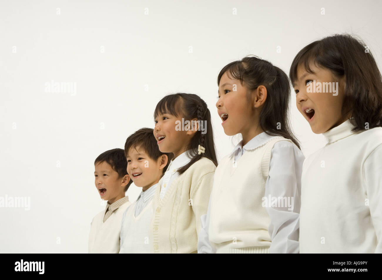 Five elementary age children standing Stock Photo - Alamy