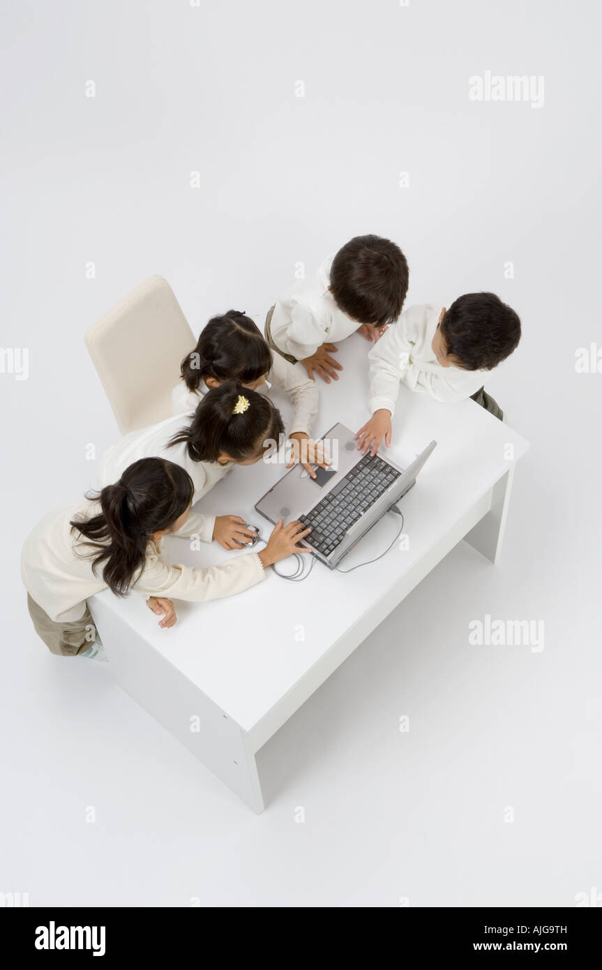 Five elementary age children using laptop Stock Photo - Alamy