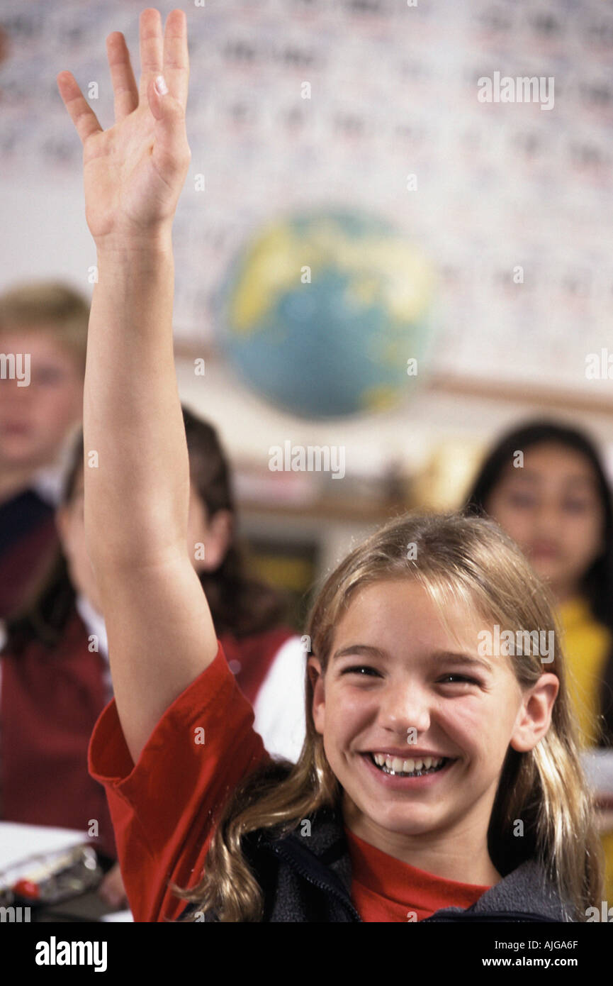 Caucasian Female Student Raising Hand In Middle School Class Stock Caucasian Female Student Raising Hand In Middle School Class Stock