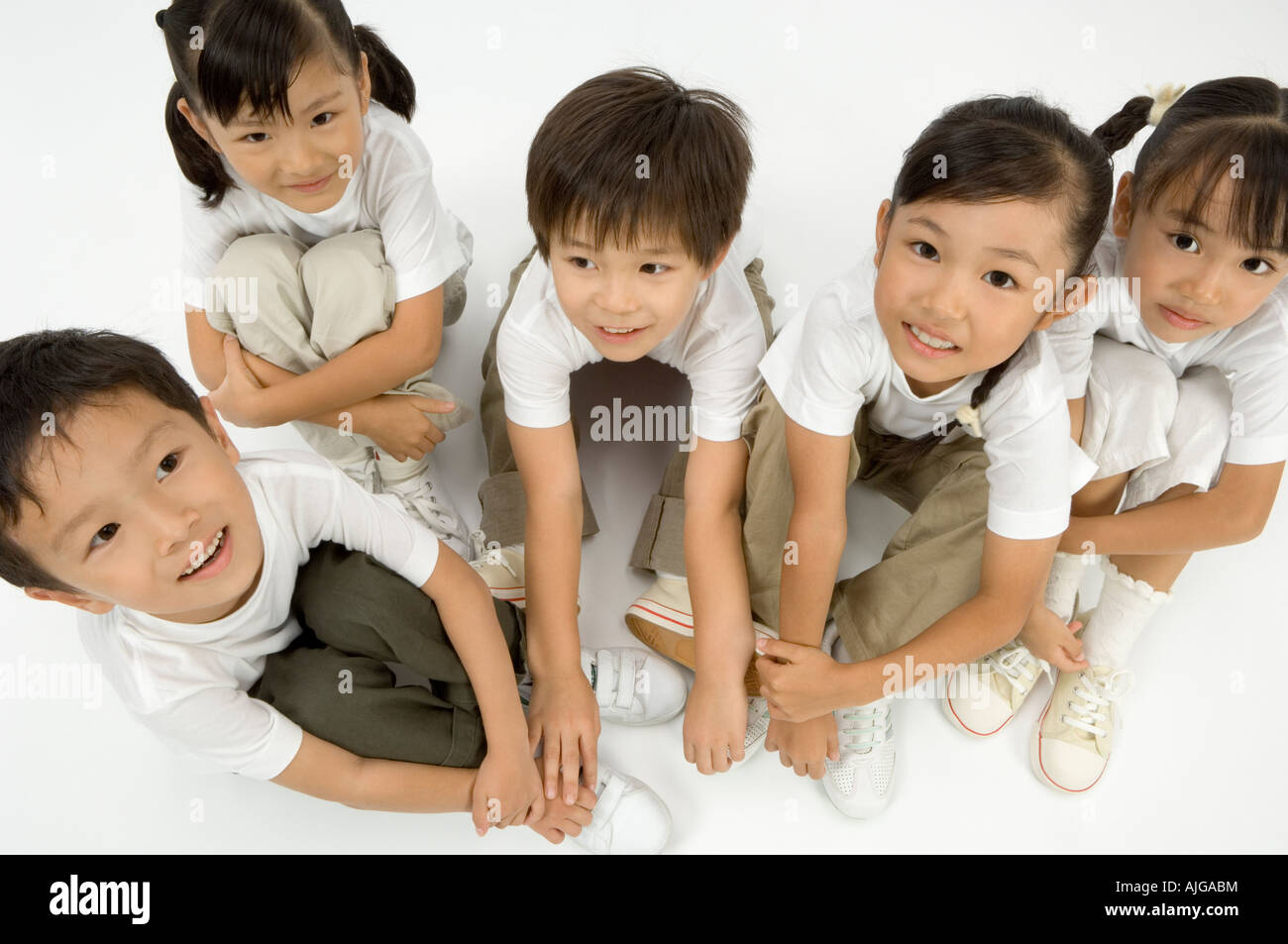 Five elementary age children sitting Stock Photo - Alamy