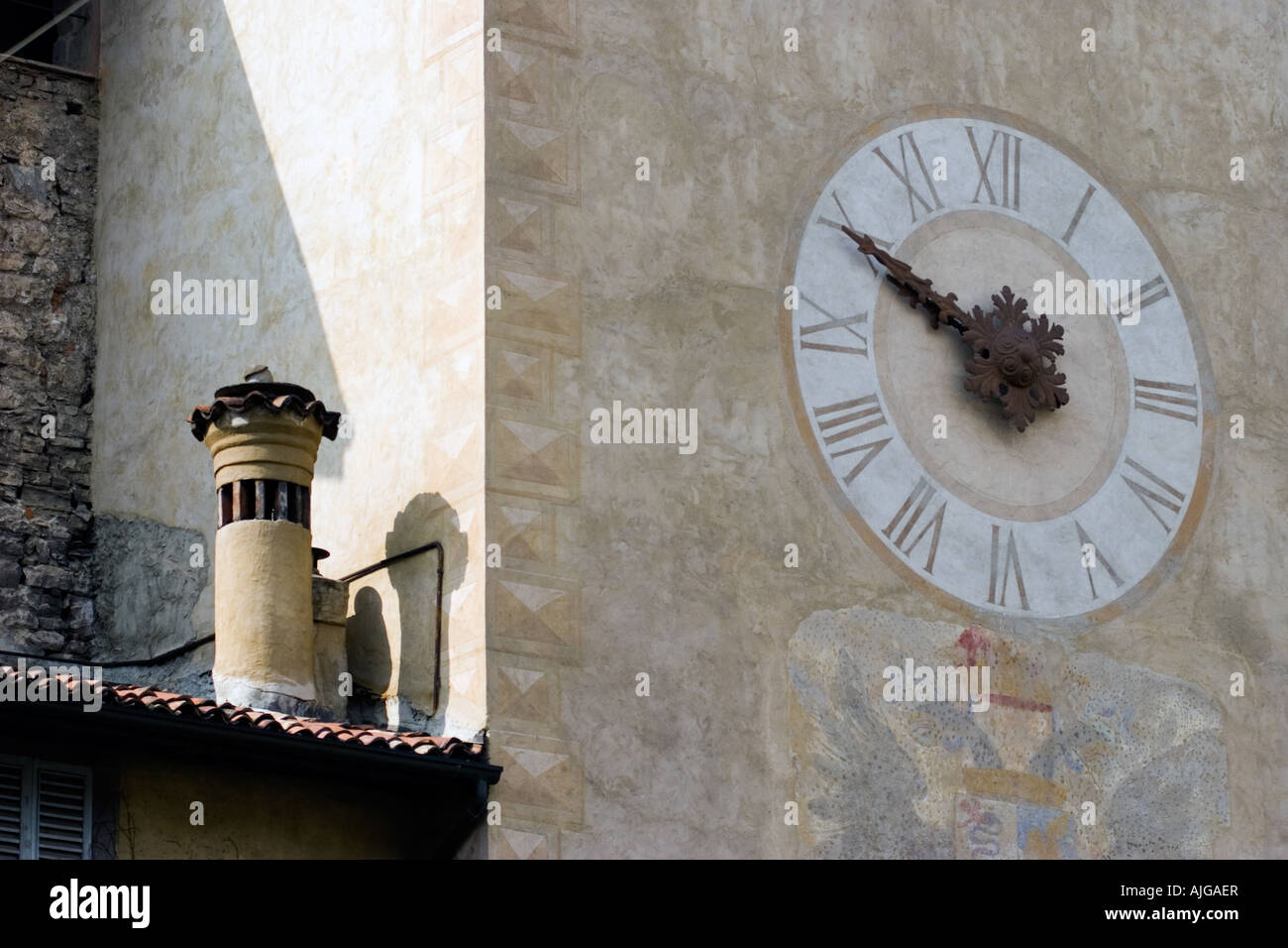 Old Clock and chimney stack in the town square of Old Bergamo Stock ...