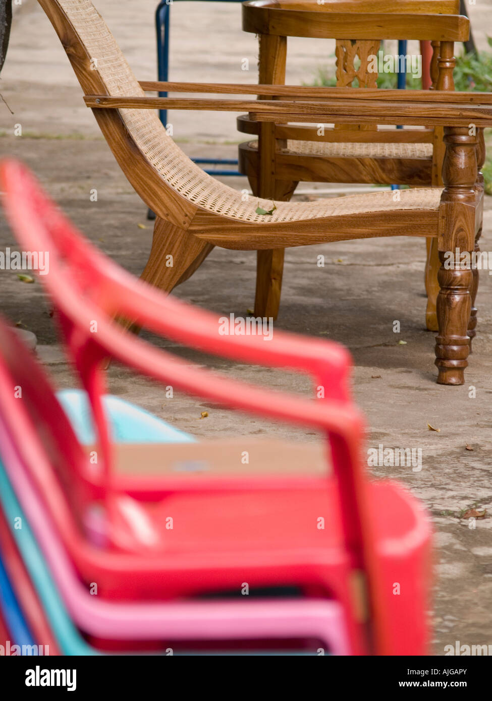Chairs made from plastic and from local materials side by side in a ...