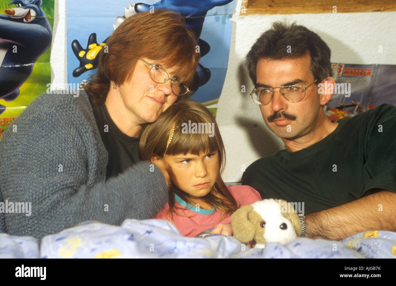 parents consoling their young daughter after a nightmare Stock Photo ...