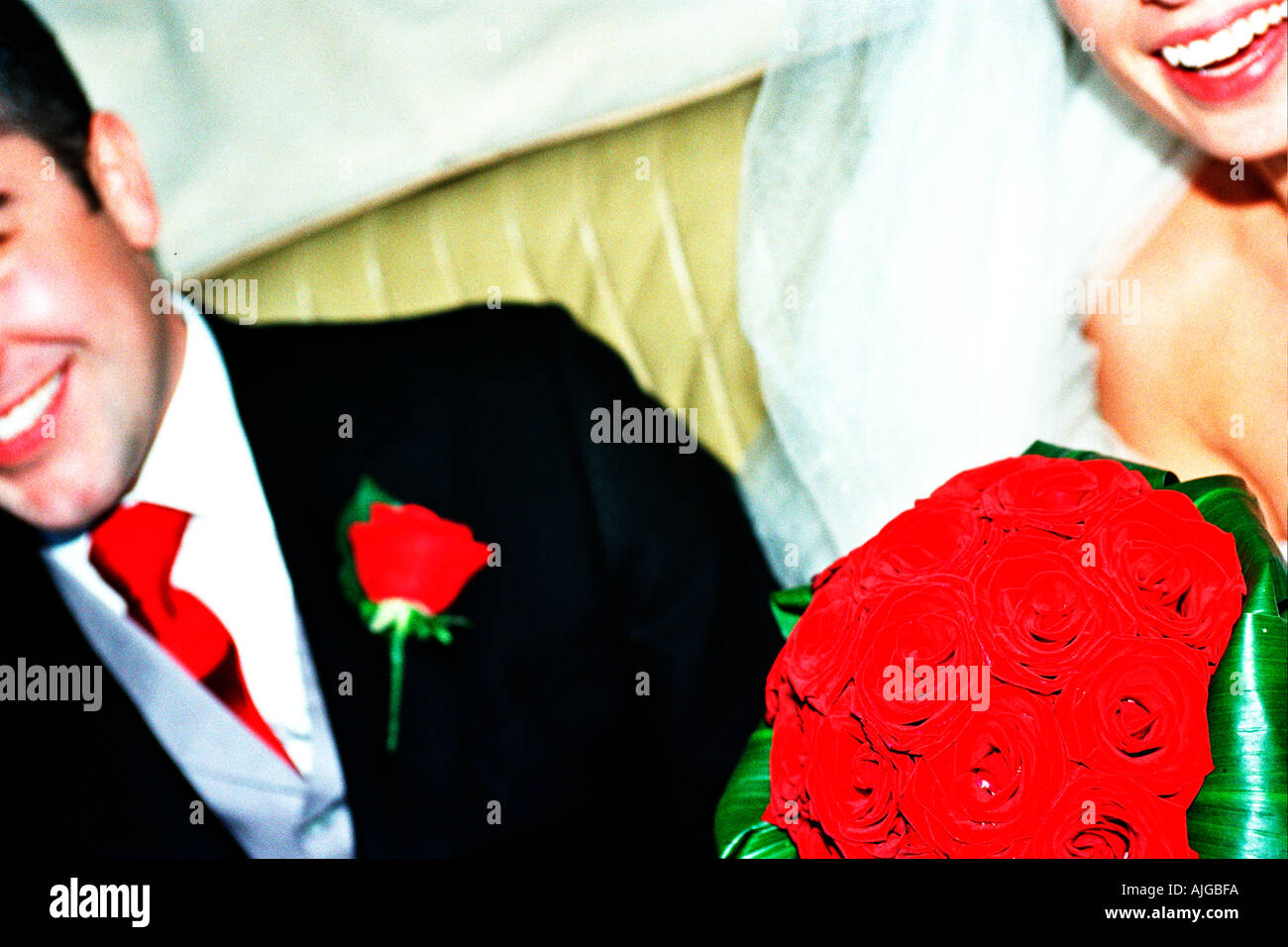 Couple leave ceremony after wedding with red bouquet Stock Photo - Alamy