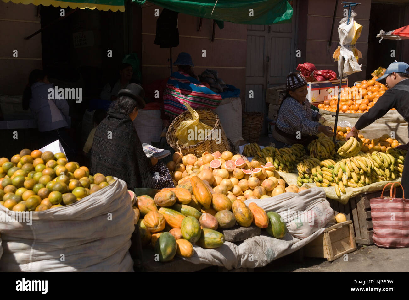 Aymara people and a food stall in the market district of La Paz ...