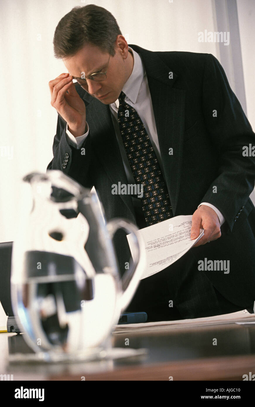Executive in a meeting going over his notes Stock Photo - Alamy