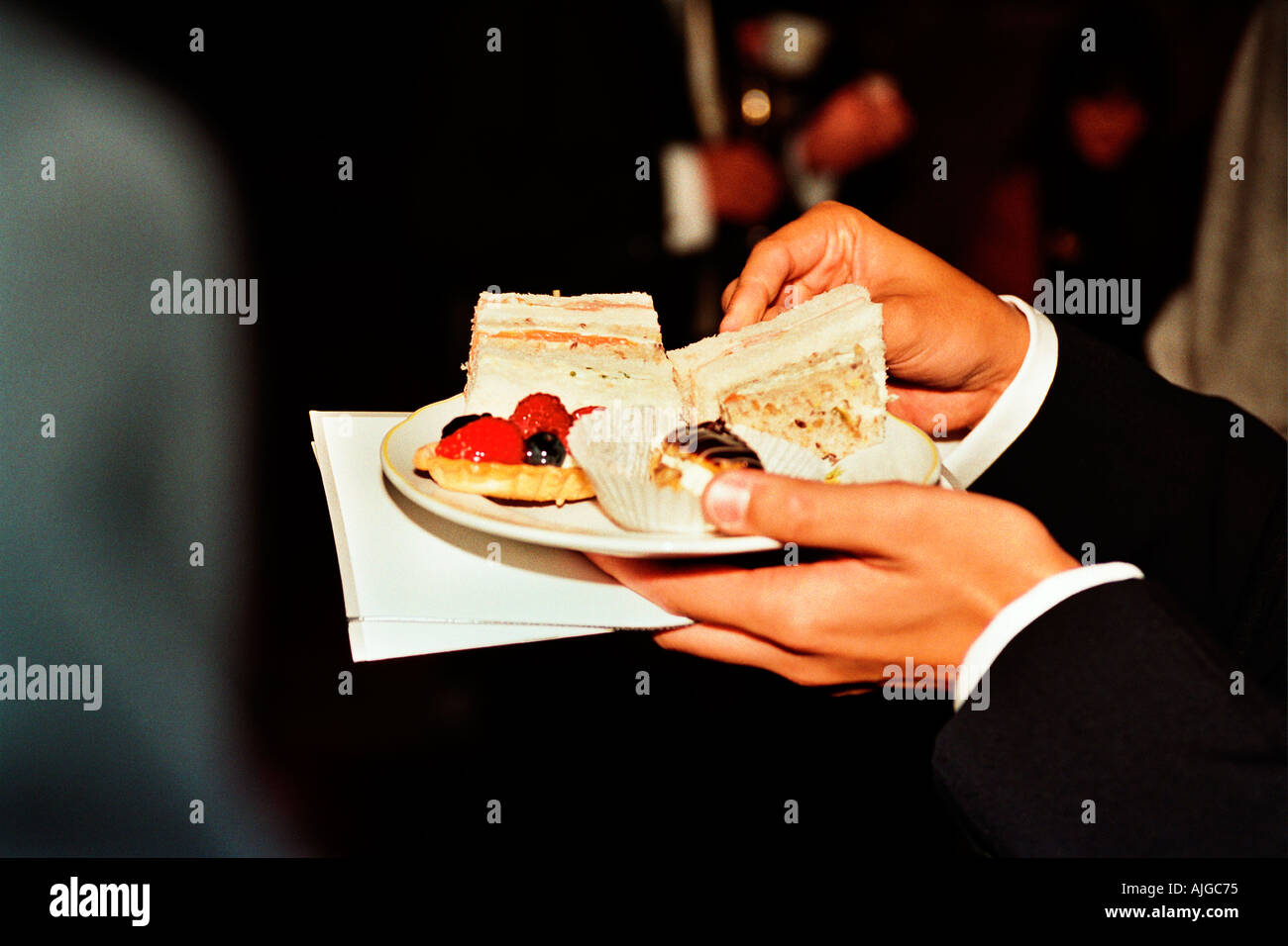 Man eating snacks from wedding buffet Stock Photo - Alamy