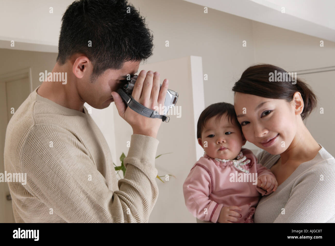 Father filming family with video camera Stock Photo - Alamy