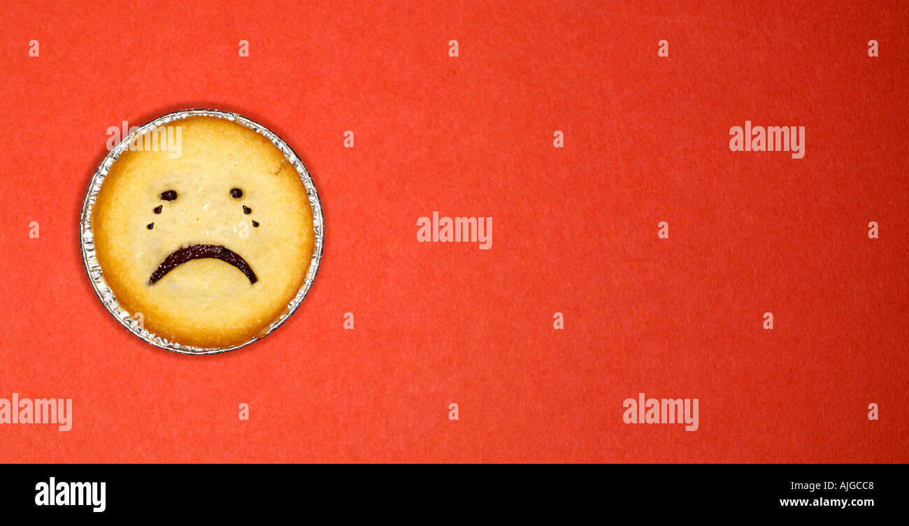 Small jam pie with a sad crying face on an orange background Another ...
