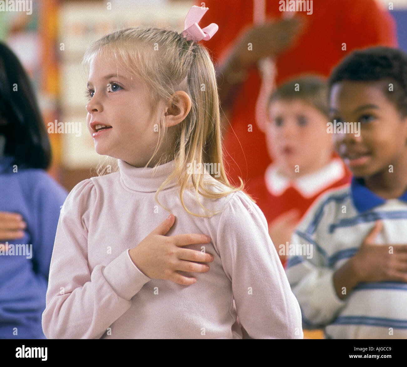 Preschool students in class pledging allegiance to the flag Stock Photo ...