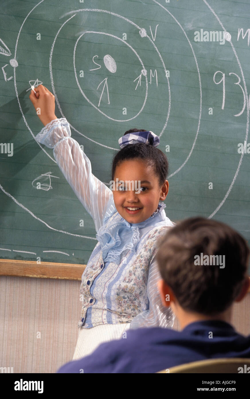 Latino female student identifying planets in science class Stock Photo ...