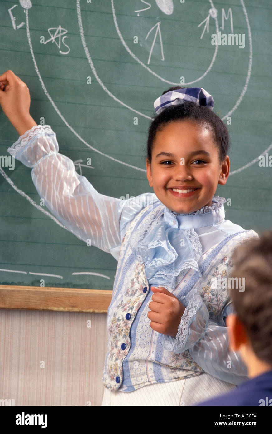 Latino female student identifying planets in science class Stock Photo ...