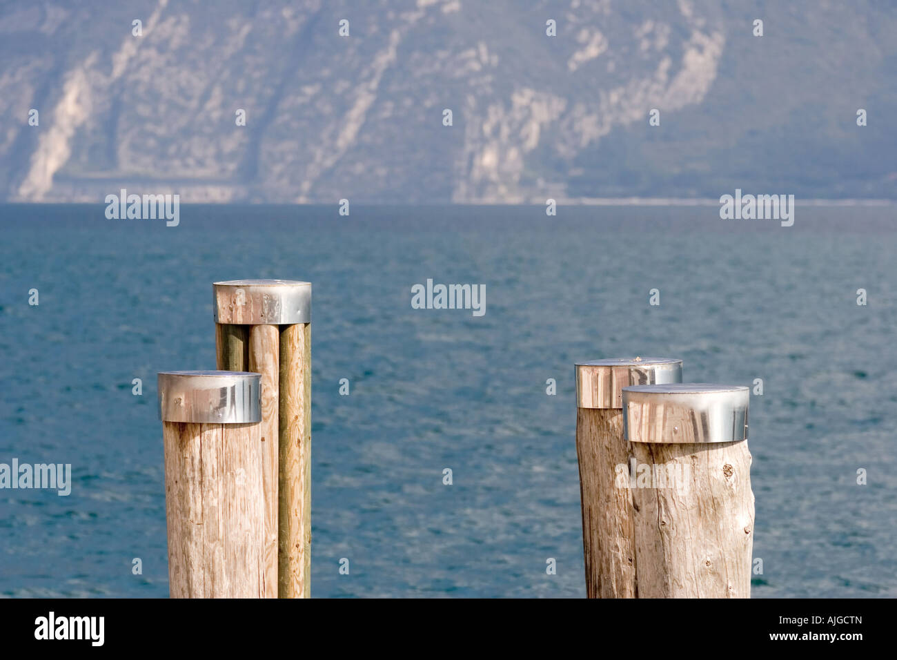 Quay posts in sunshine on Lake Garda Stock Photo - Alamy