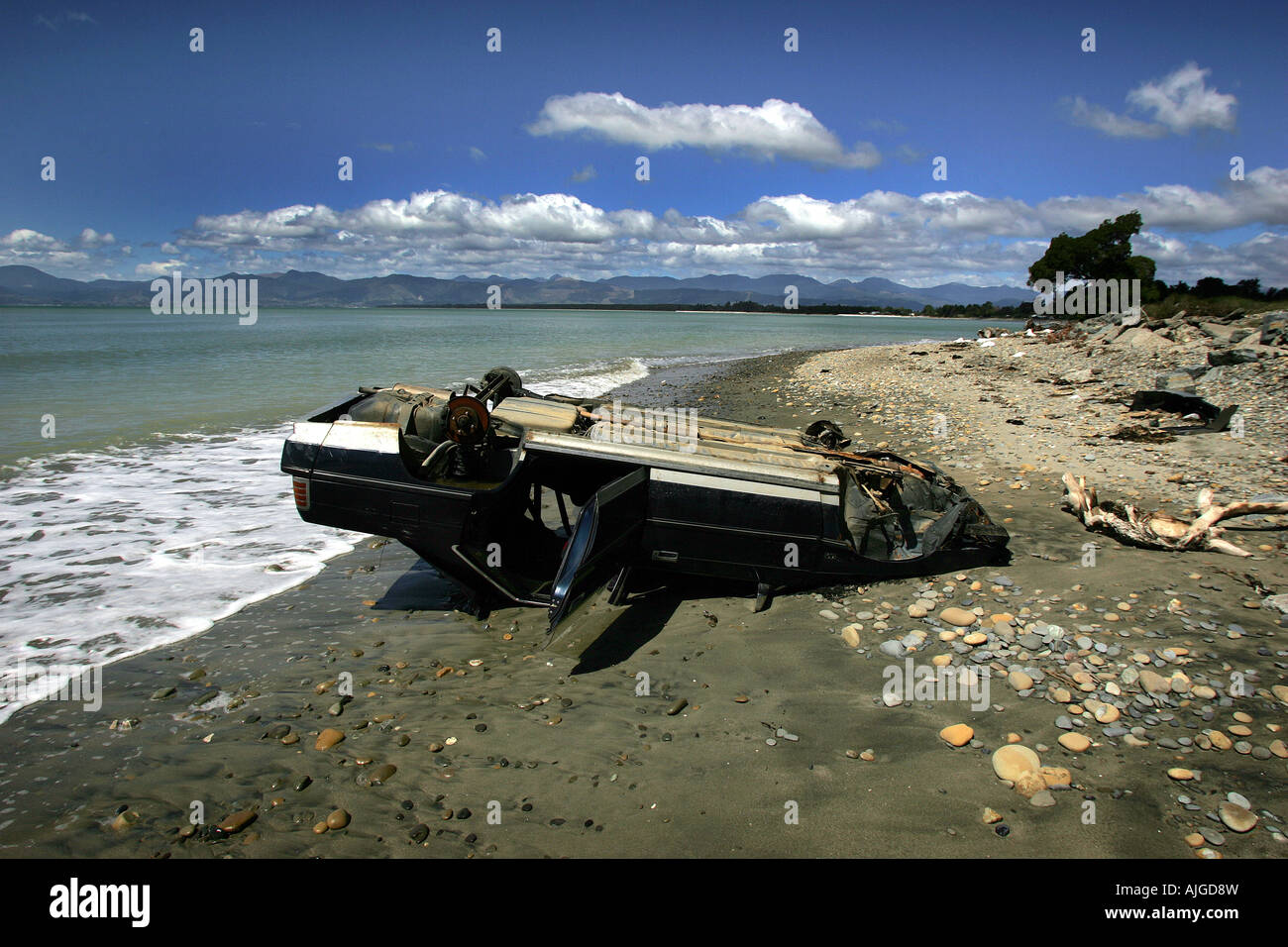 Car wreck upside down on scenic beach Ruby Bay Nelson New Zealand Stock ...