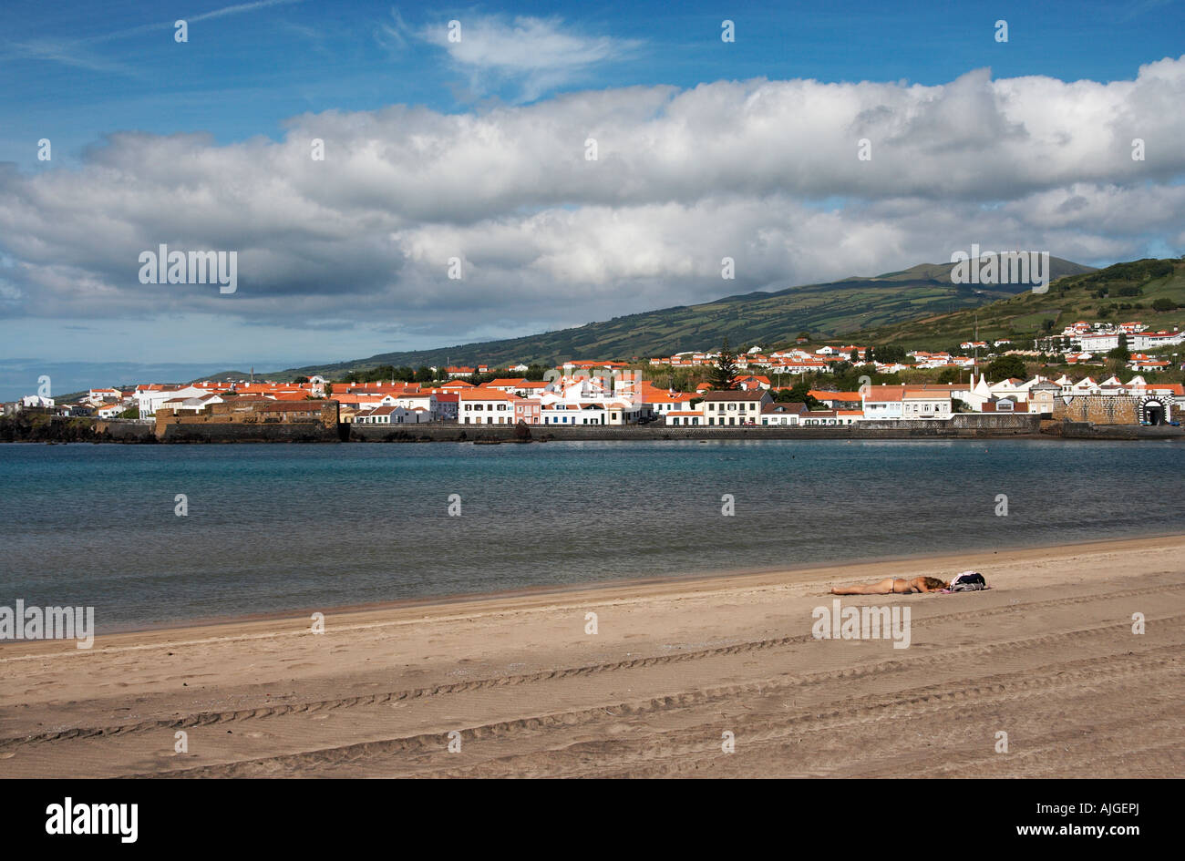 Lone female sunbathing on the beach in Baia de Porto Pim, Horta, Fail ...