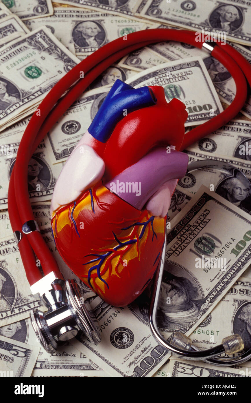 Heart model with stethoscope on money Stock Photo - Alamy