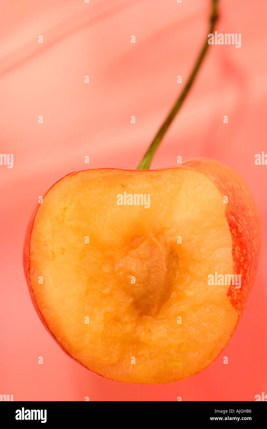 Bite taken from a Rainier cherry with stem Stock Photo - Alamy