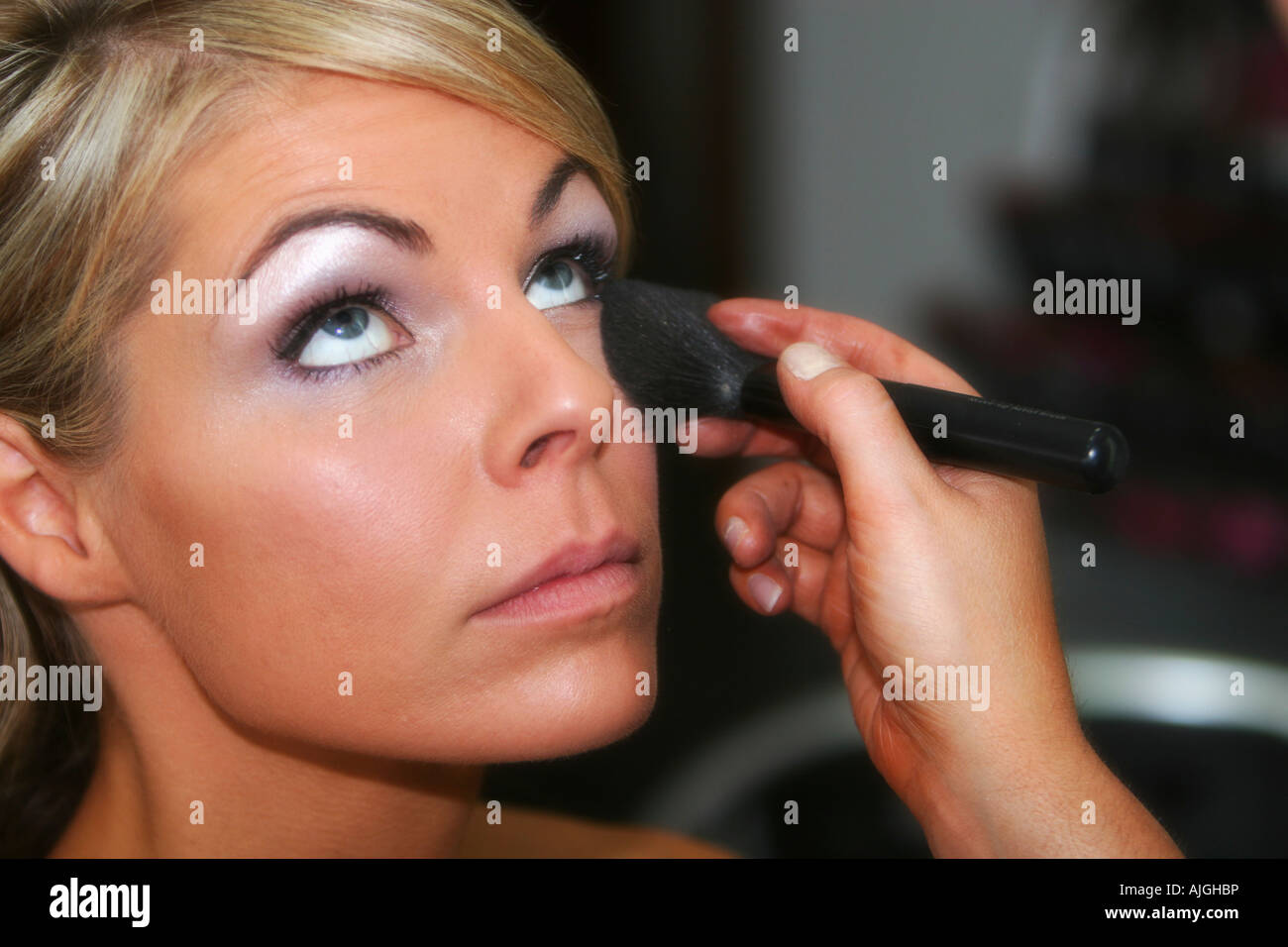 Very pretty woman at a makeup artists saloon getting a full makeup ...
