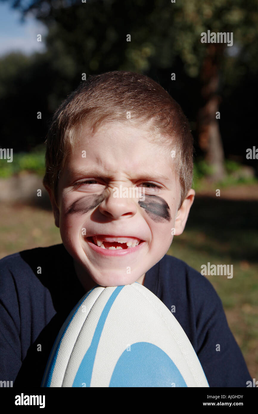 young eight seven year old boy missing two front teeth chin resting on ...
