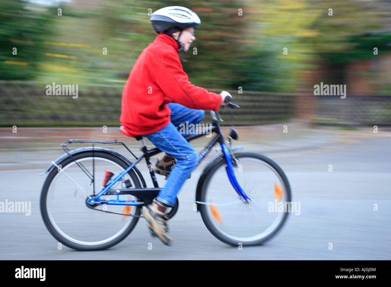 young boy with a helmet on a bike Stock Photo - Alamy