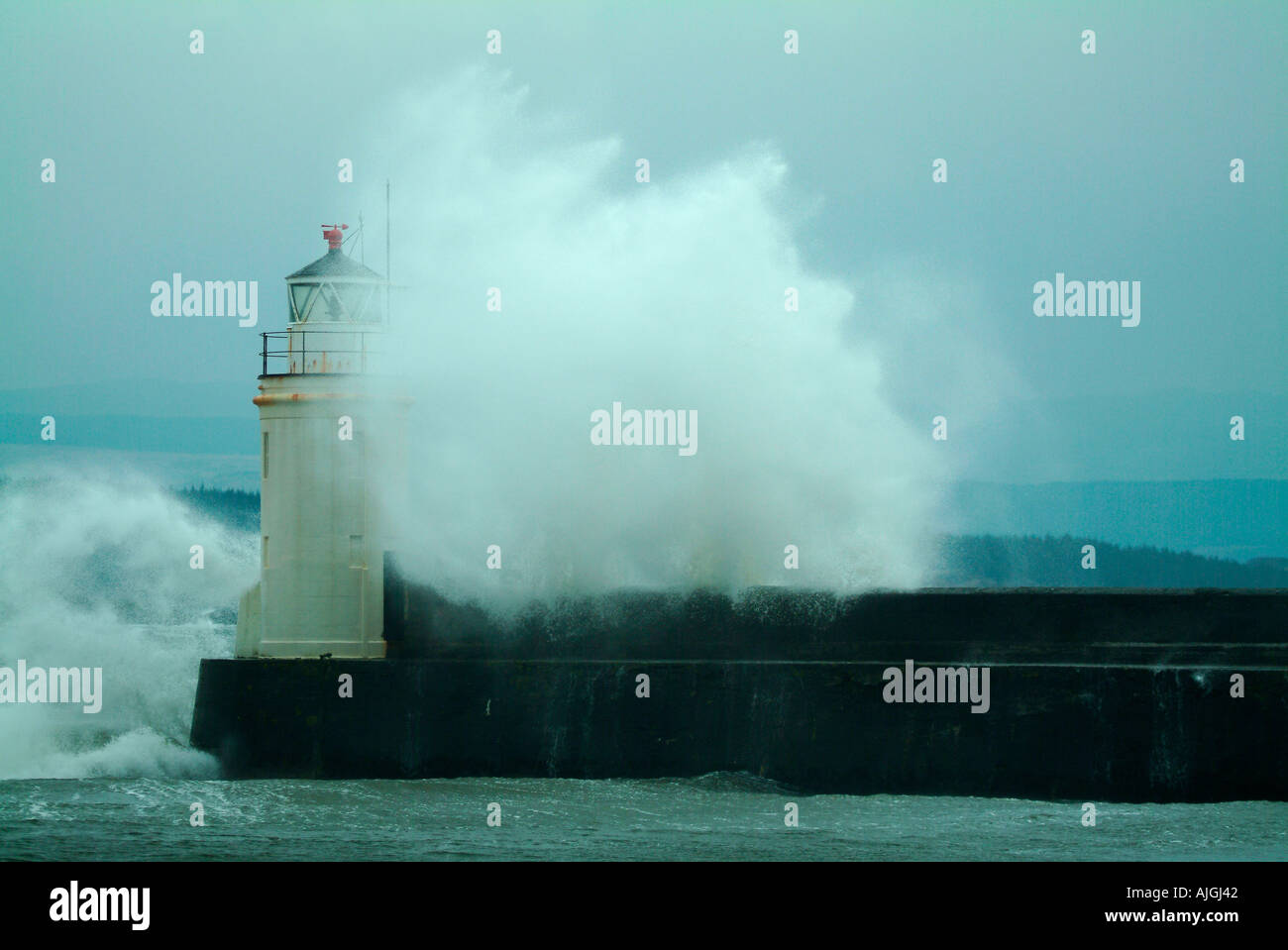 Waves crashing over lighthouse during storm Stock Photo - Alamy