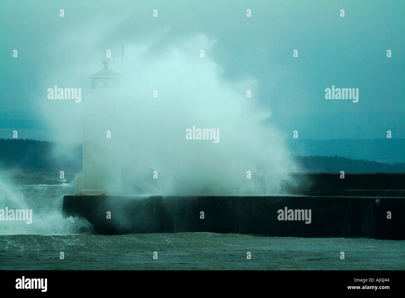 Waves crashing over lighthouse during storm Stock Photo - Alamy