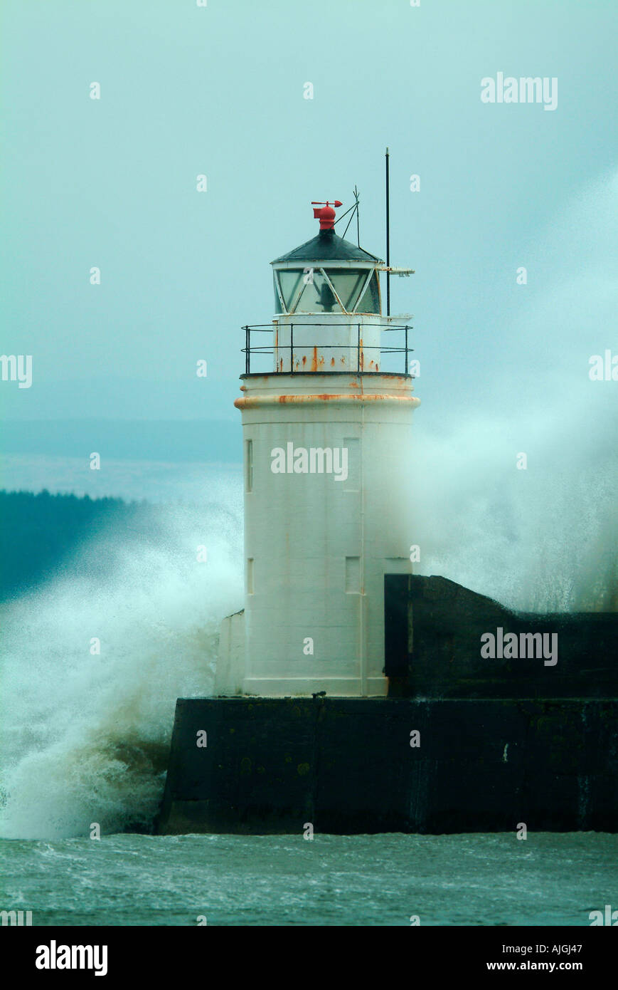 Waves crashing over lighthouse during storm Stock Photo - Alamy