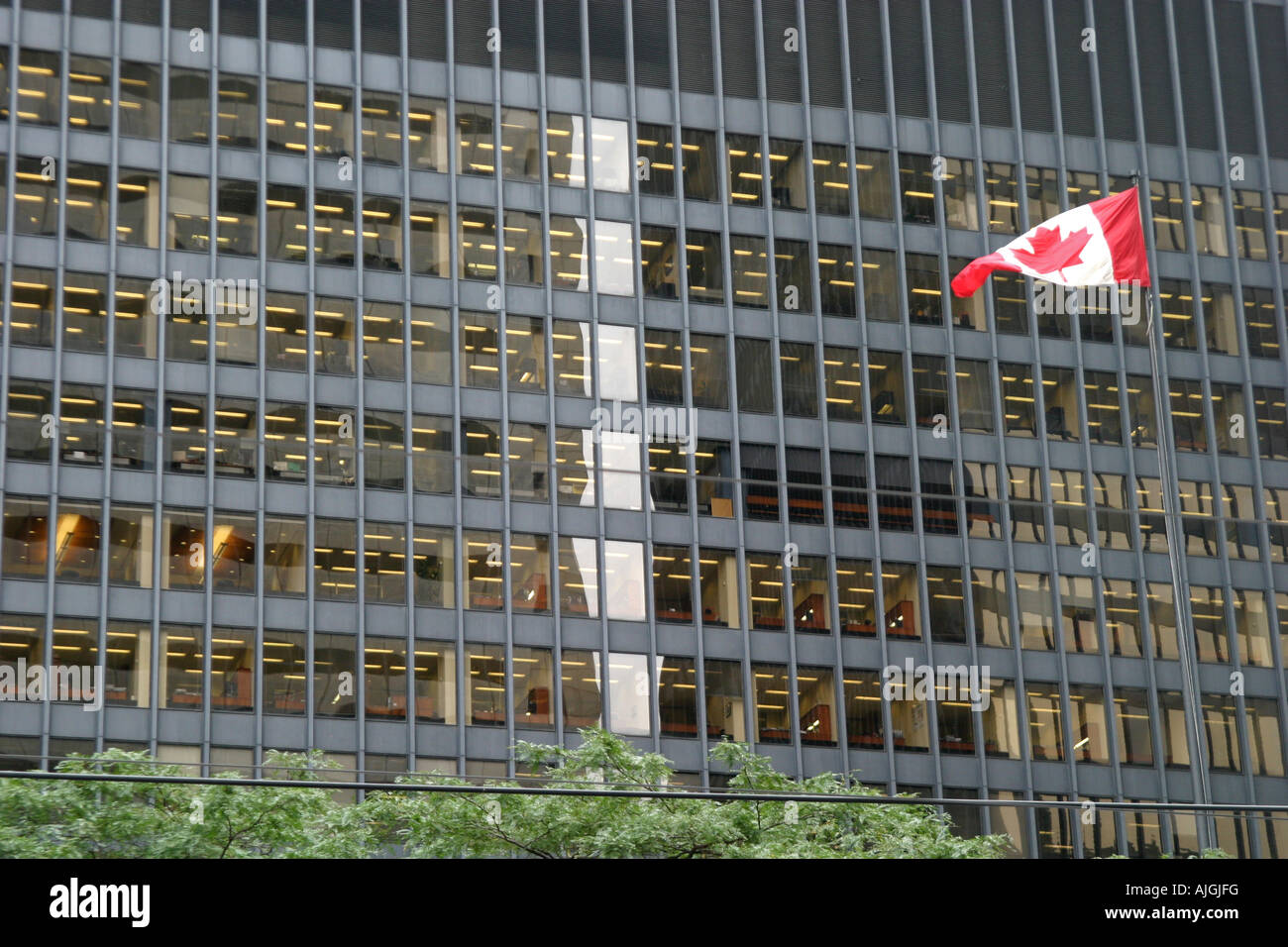 red canadian flag flying against black skyscraper windows Stock Photo ...