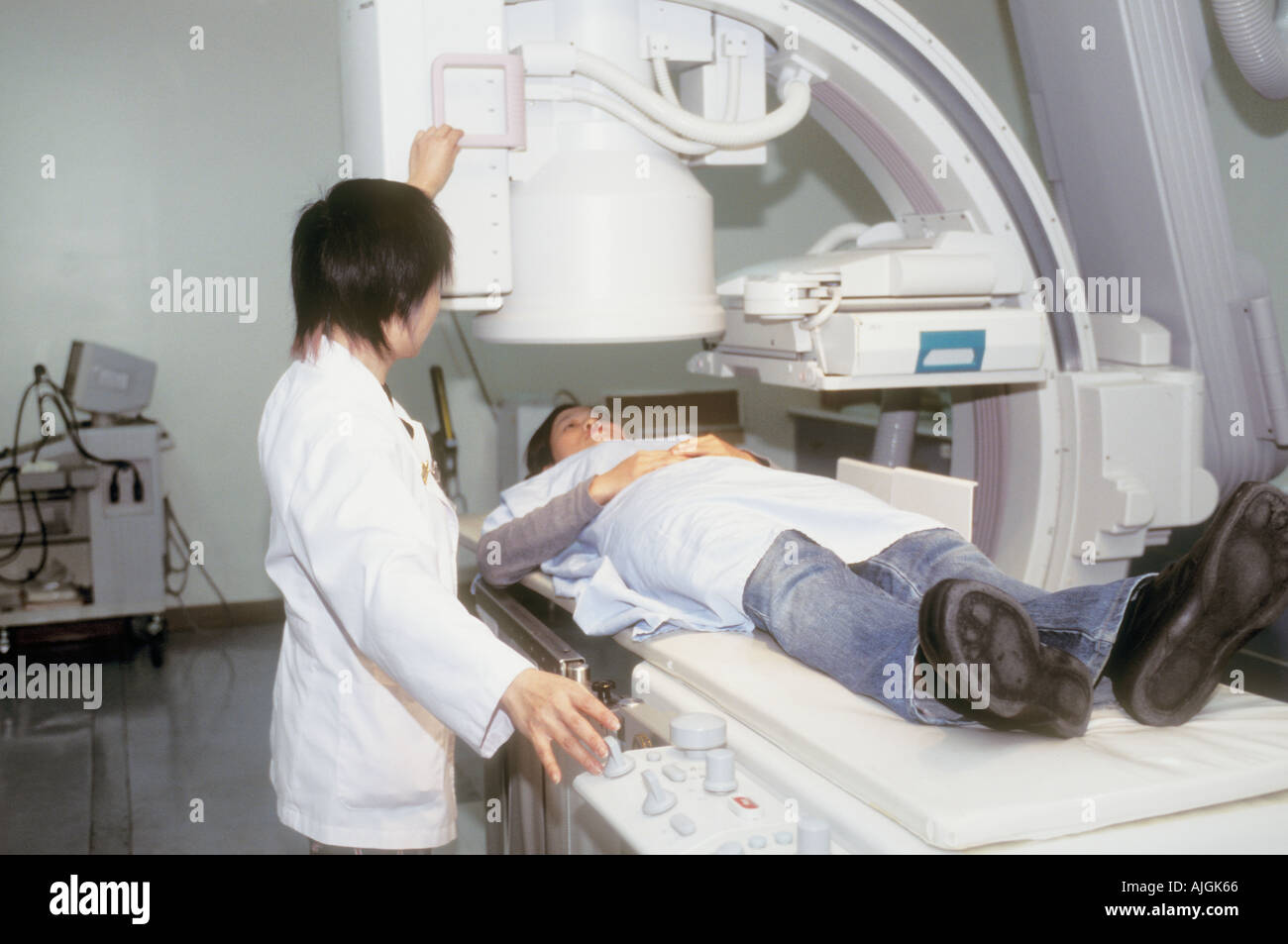 Asian doctor preparing to X ray patient in hospital radiology ...