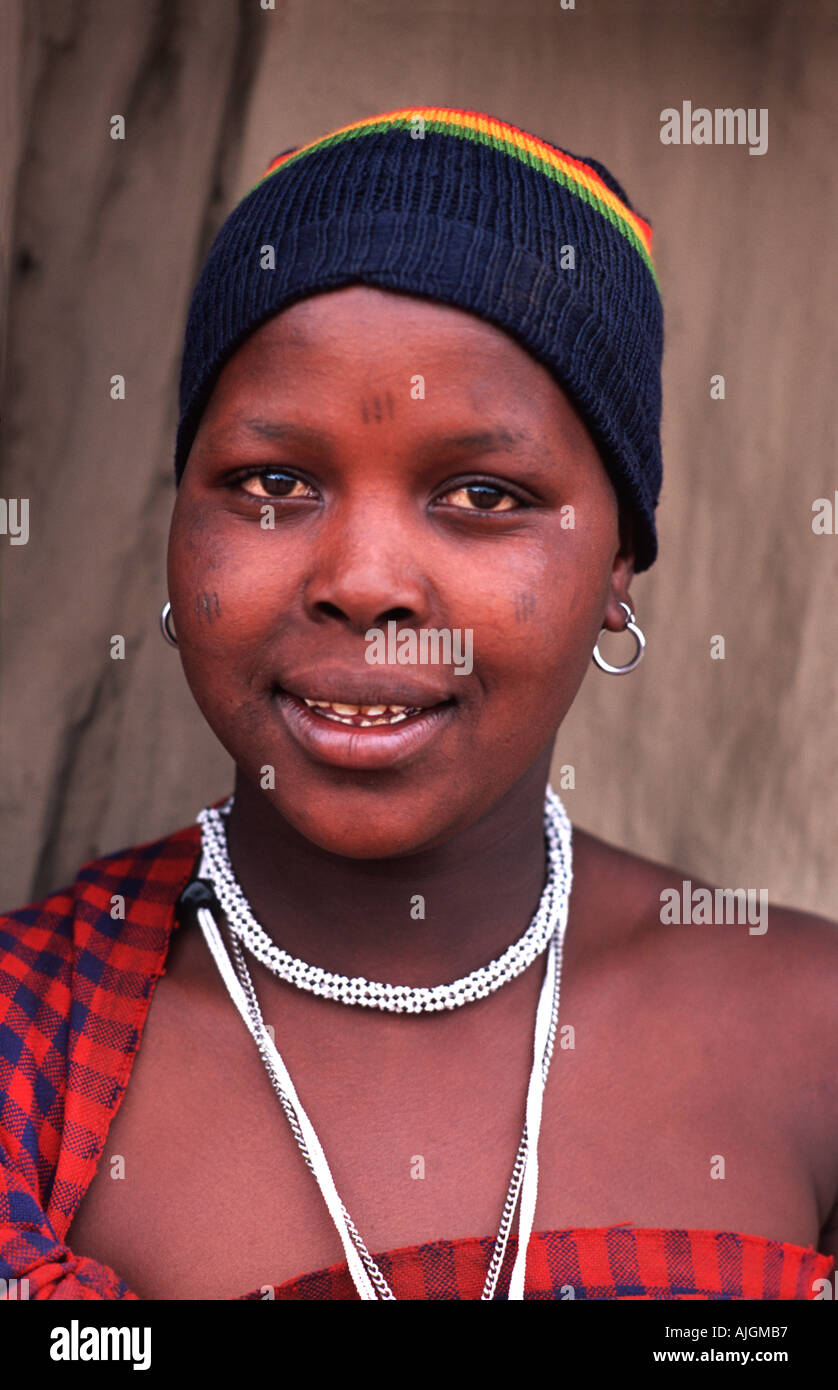 Masai woman in tribal dress and a rastafarian coloured cap north of ...