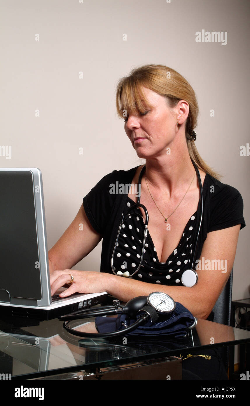 Doctor in a Surgery Using a Laptop Computer Medical Practitioner Stock ...