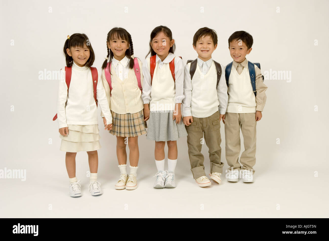 Five elementary age children standing Stock Photo - Alamy
