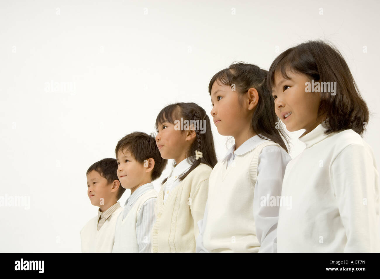 Five elementary age children standing Stock Photo - Alamy