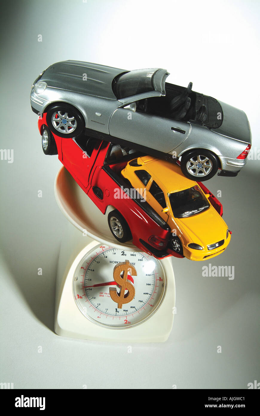 High angle view of a stack of toy cars on a weighing scale Stock Photo ...