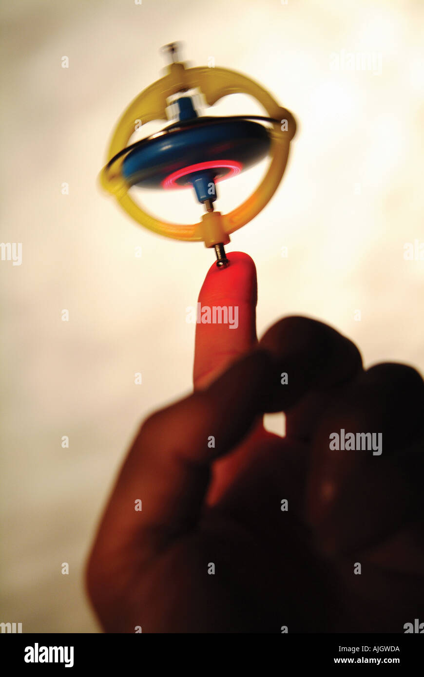 Low angle view of a top spinning on a person s finger Stock Photo - Alamy