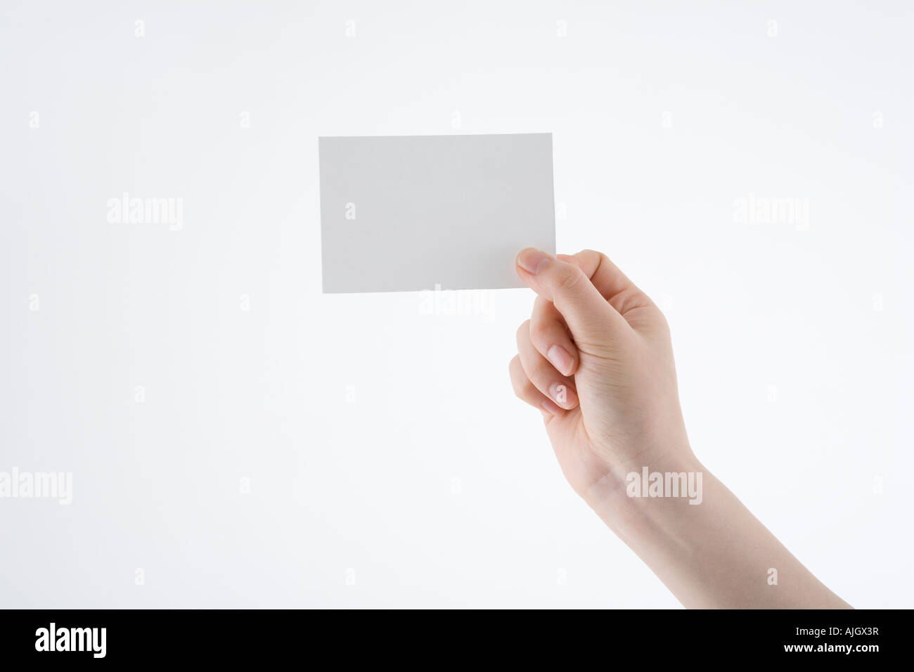 Woman's hand holding card Stock Photo - Alamy