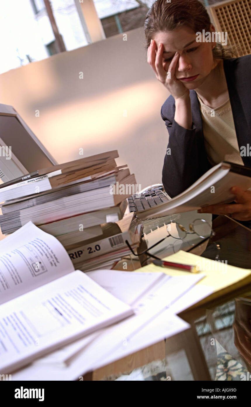 Business woman overwhelmed by work Stock Photo - Alamy