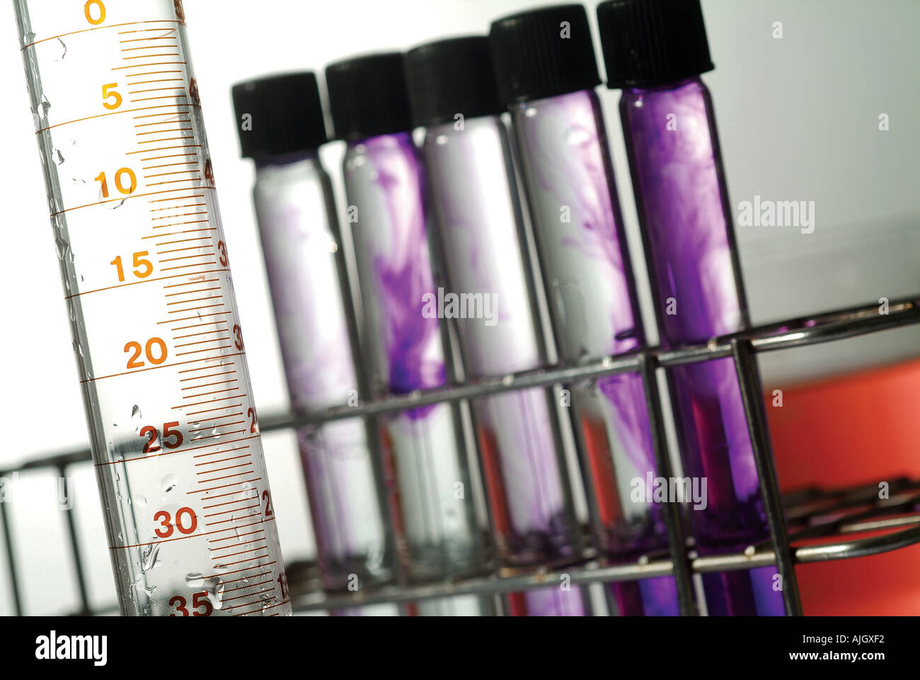 Close up of a scale beside a rack of test tubes Stock Photo - Alamy