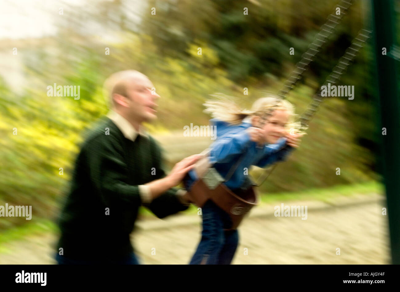 Child kid pushing swing hi-res stock photography and images - Alamy