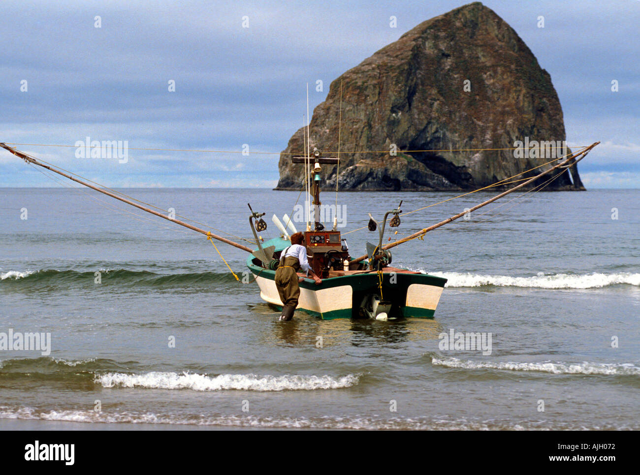 A Dory fishing boat is launched at Cape Kiwanda Pacific City Oregon ...