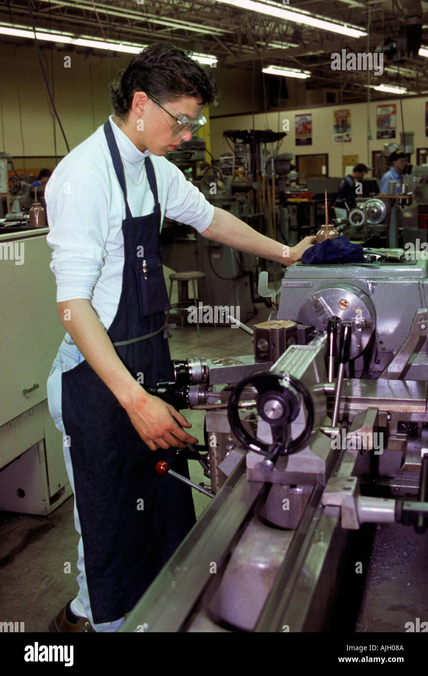 High School vocational technology class male student learns machine ...