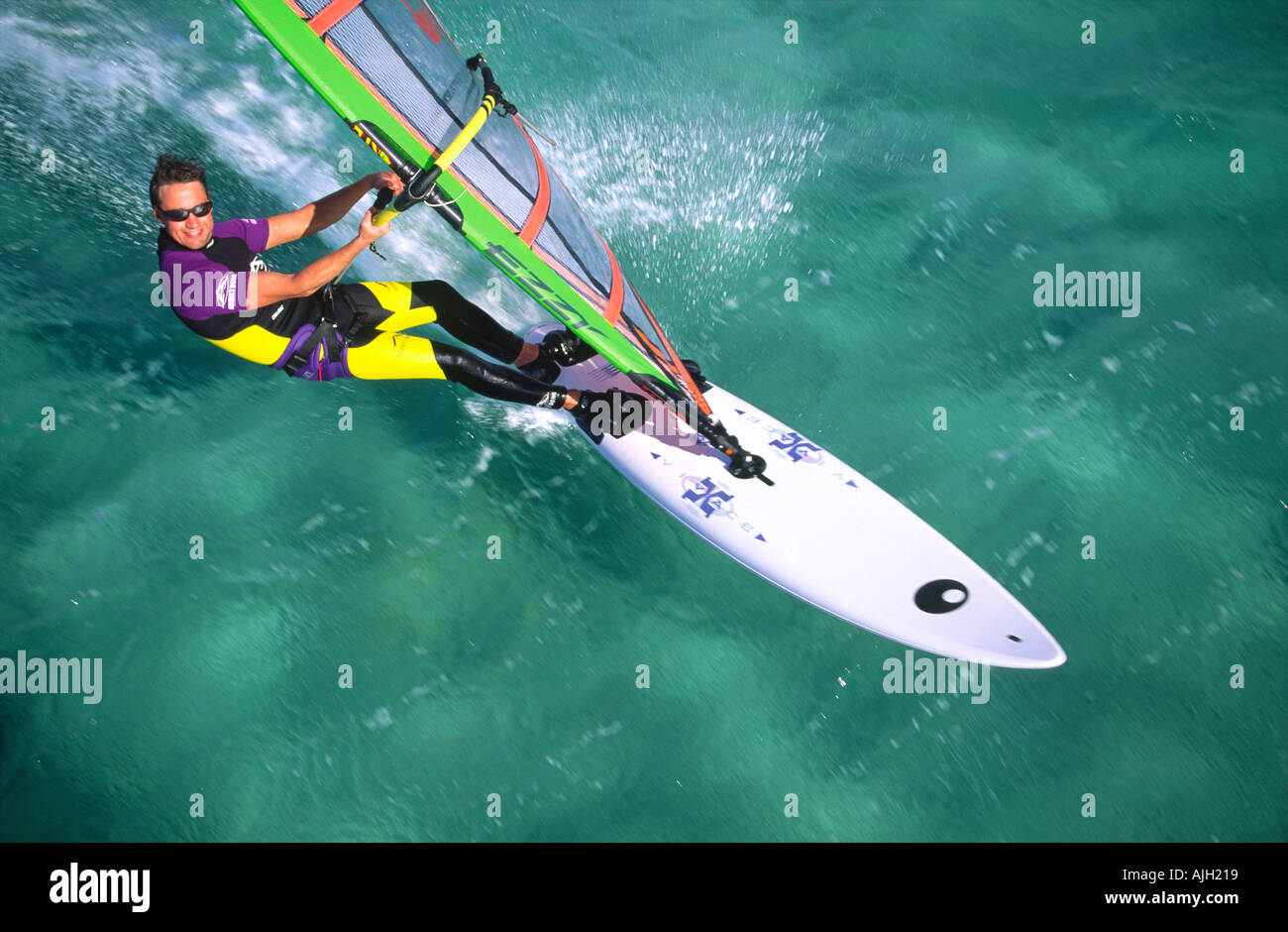 aerial view of solo windsurfer sailing looking at viewer on Red Sea ...