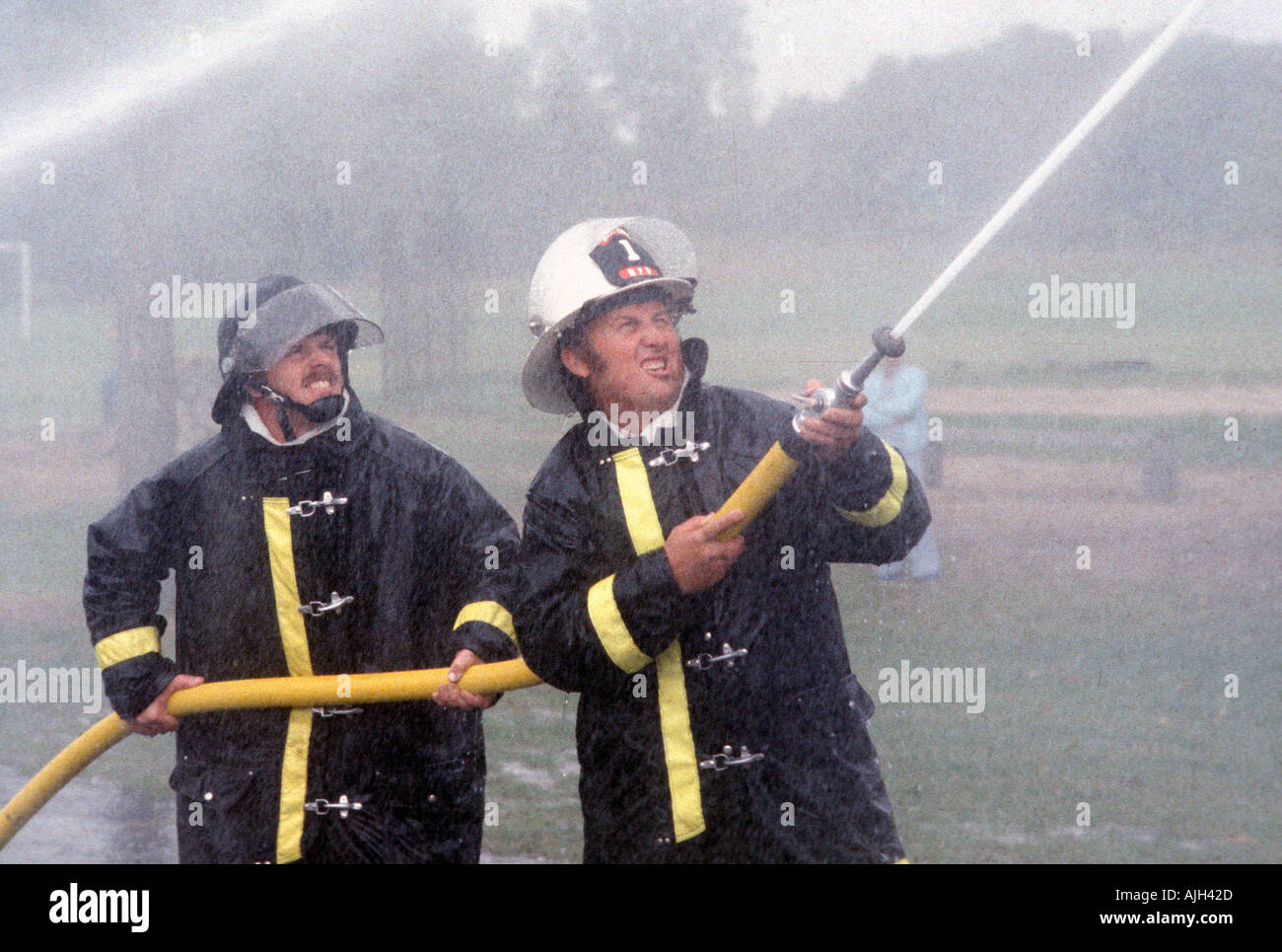 2 Volunteer firefighters battle a fire Stock Photo - Alamy