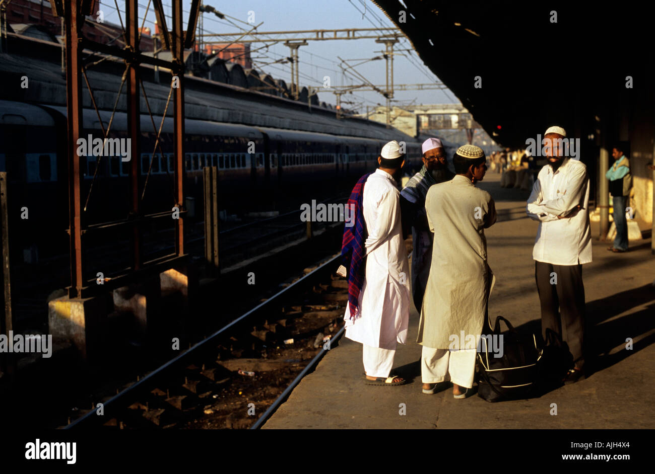 Muslim men waiting for train, Old Delhi, India Stock Photo - Alamy